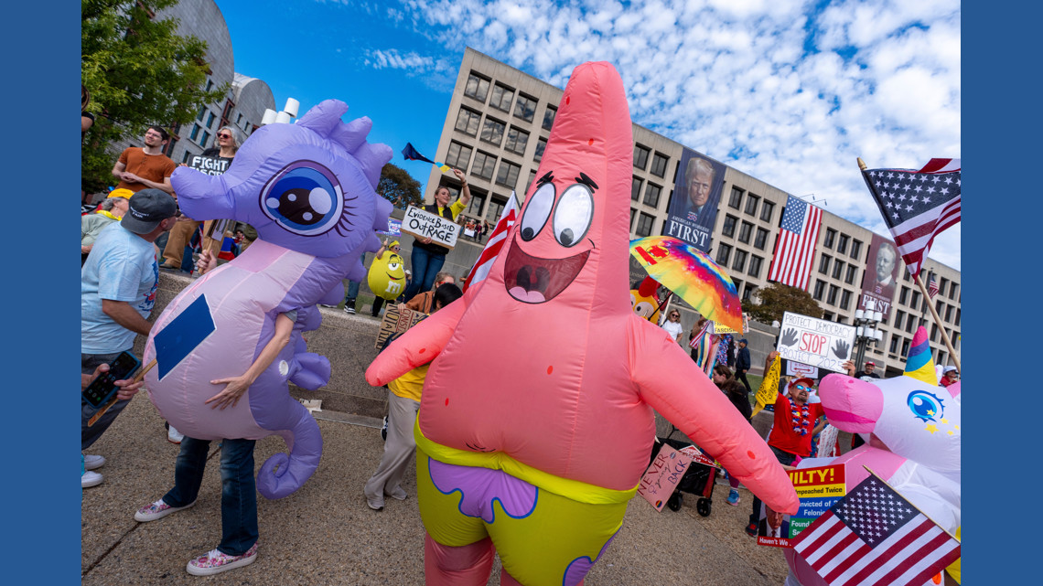Inflatable costumes used to deflate tensions at rallies against Trump ...
