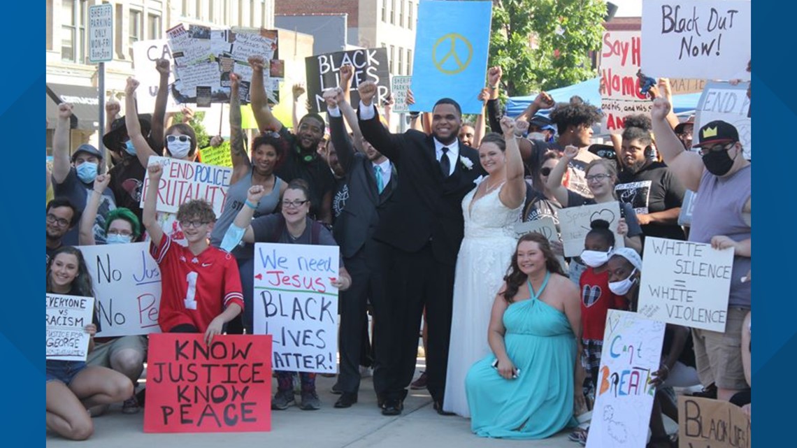 Newlyweds pose with racial justice marchers in downtown Findlay | wtol.com