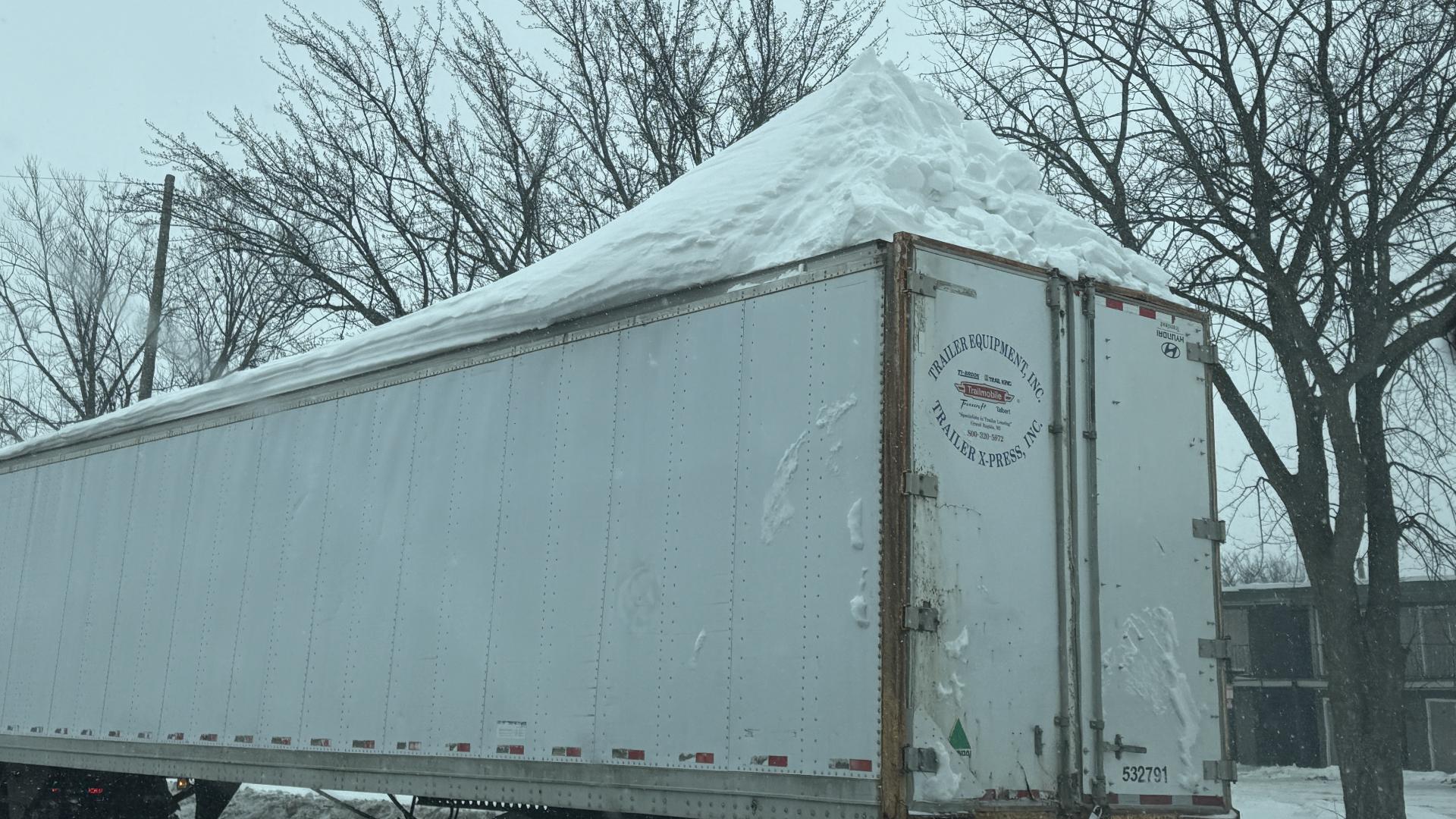 Driver cited after snow piled so high on top of semi that it hit ...